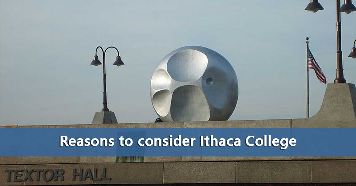 A large metal sculpture sits atop a concrete structure. The text on the ...